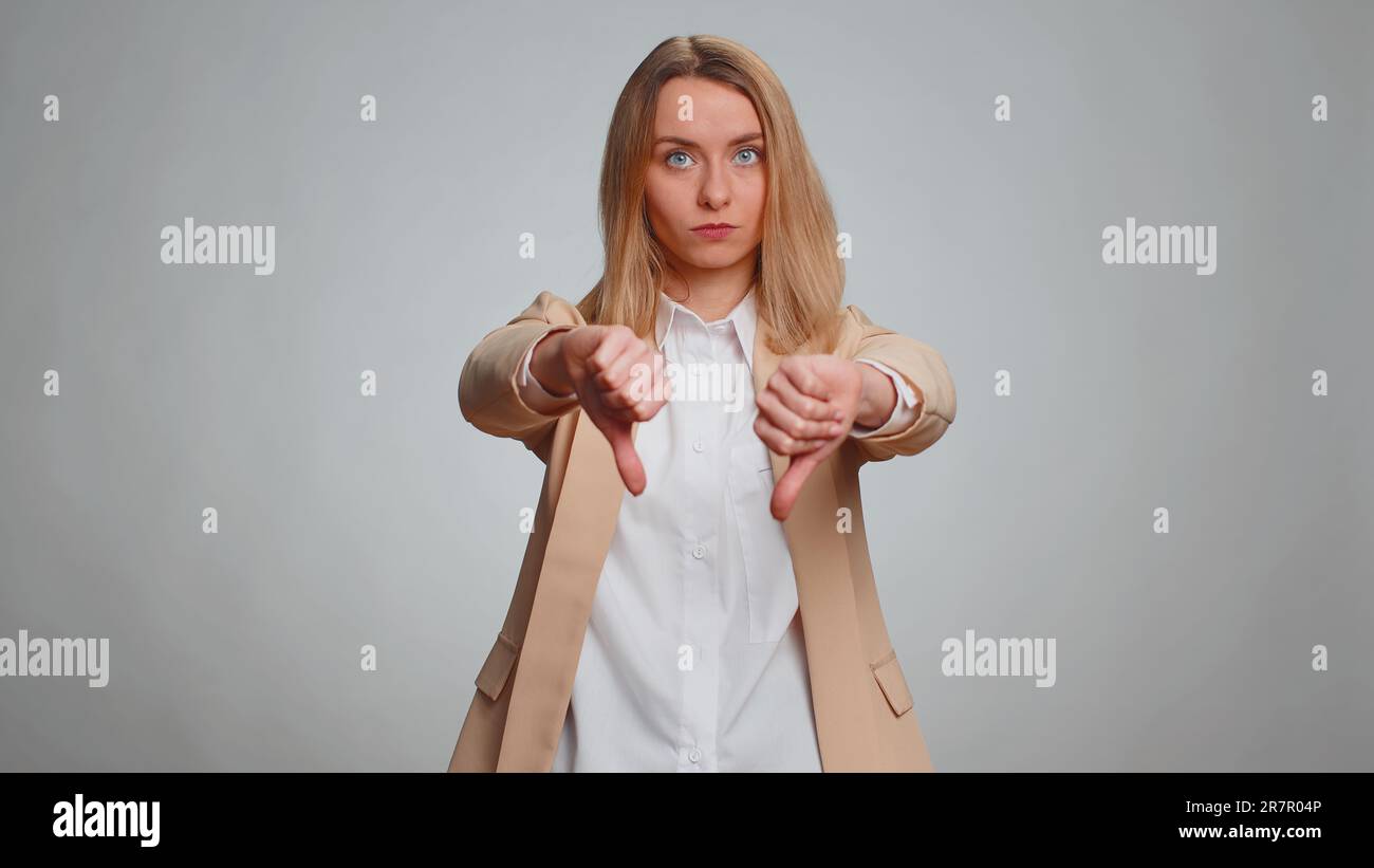 Dislike. Upset unhappy office woman in suit showing thumbs down sign ...