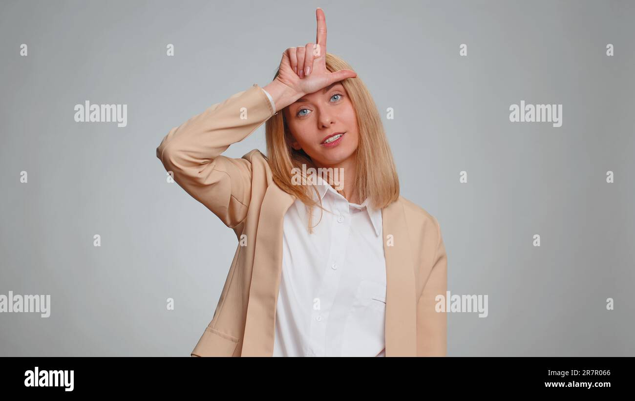 Business woman showing loser gesture and pointing on you, blaming ...