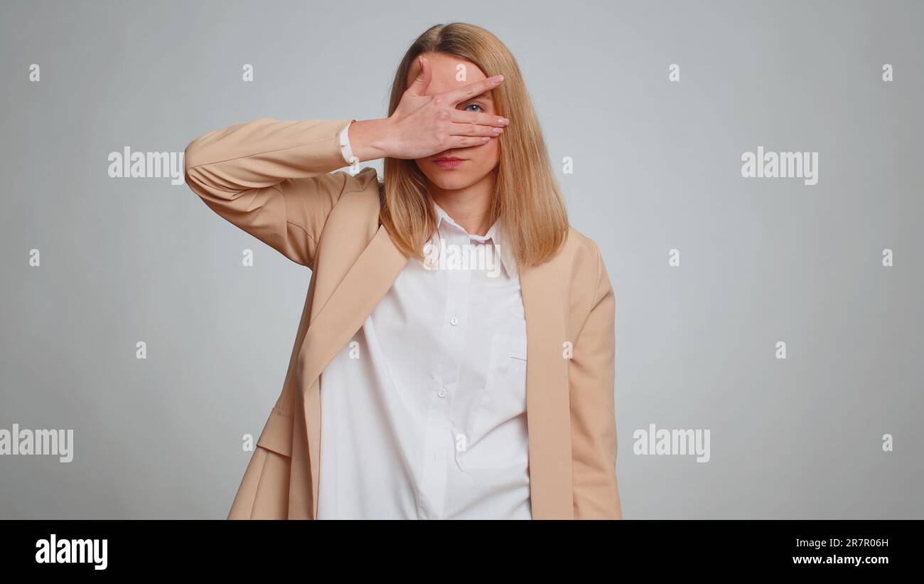 Nosy curious business woman closing eyes with hand and spying through ...