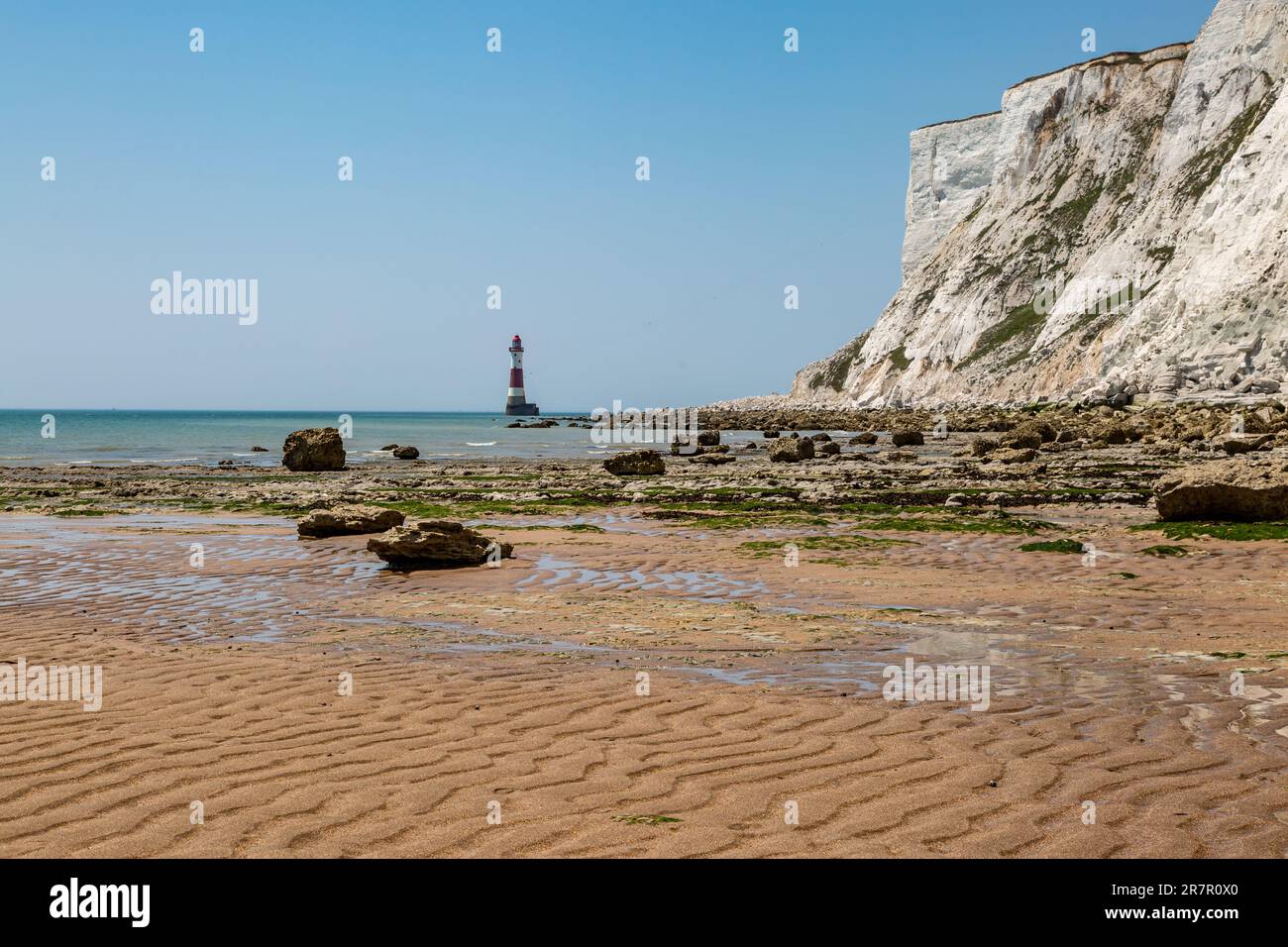 Low tide revealing a sandy beach, near Beachy Head Lighthouse off the ...