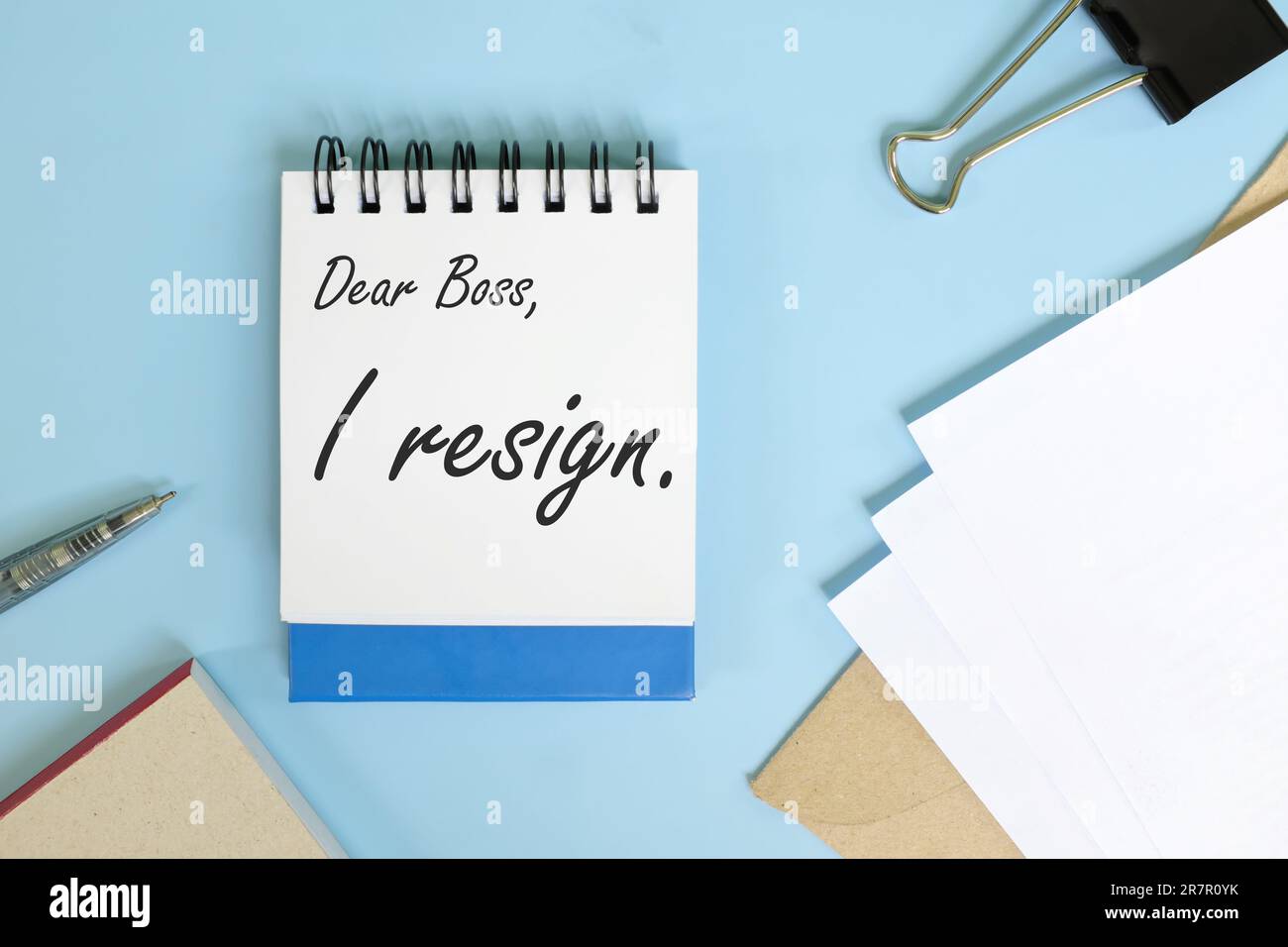 Workplace resignation concept. Office flat lay of blue notepad with I ...