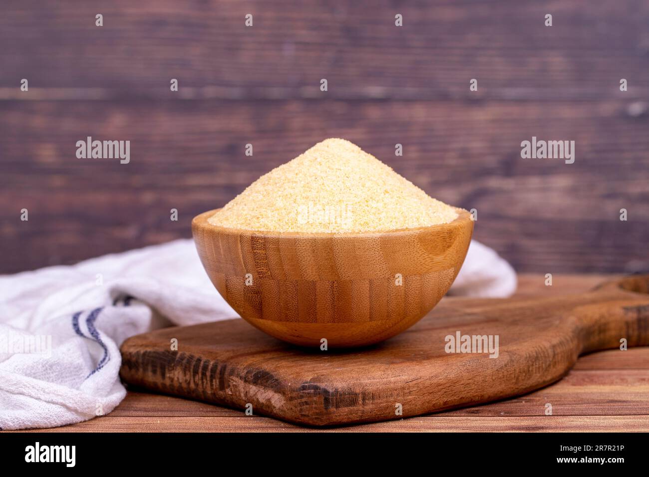 Dry organic semolina flour on wooden background. Uncooked organic ...