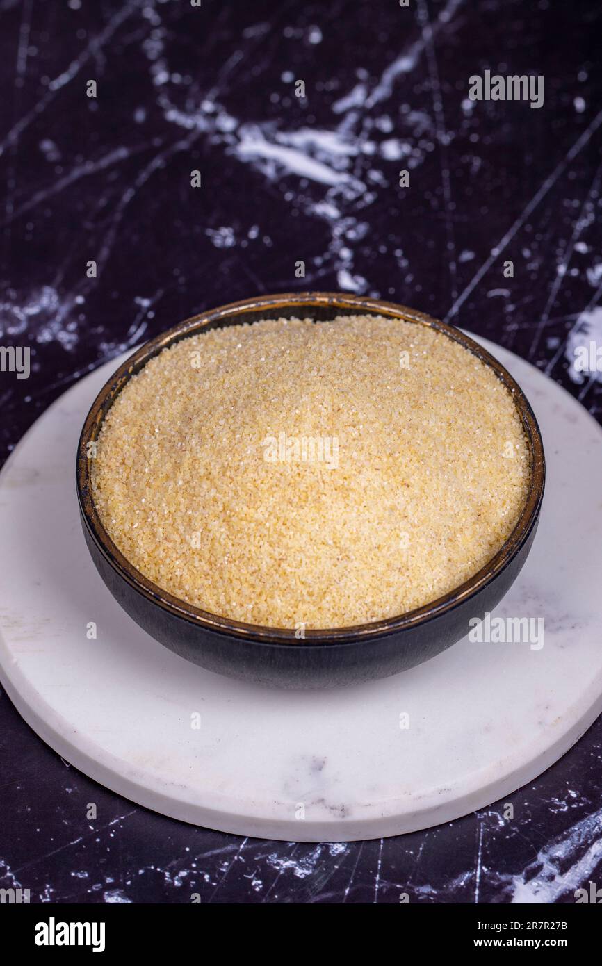 Dry organic semolina durum flour on dark background. Uncooked organic ...