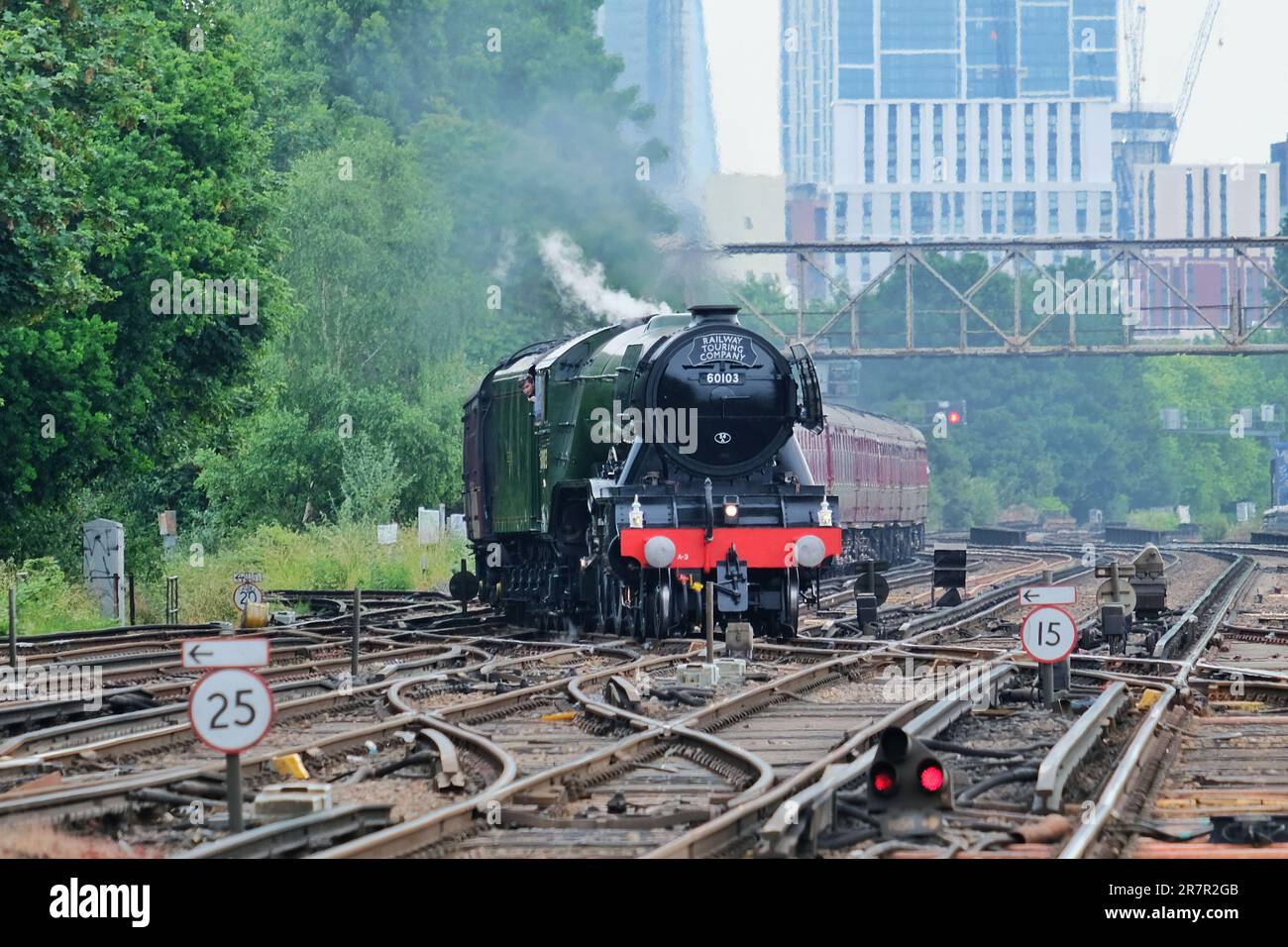 London, UK. 17th June, 2023. The Flying Scotsman locomotive passes through Clapham Junction as ...