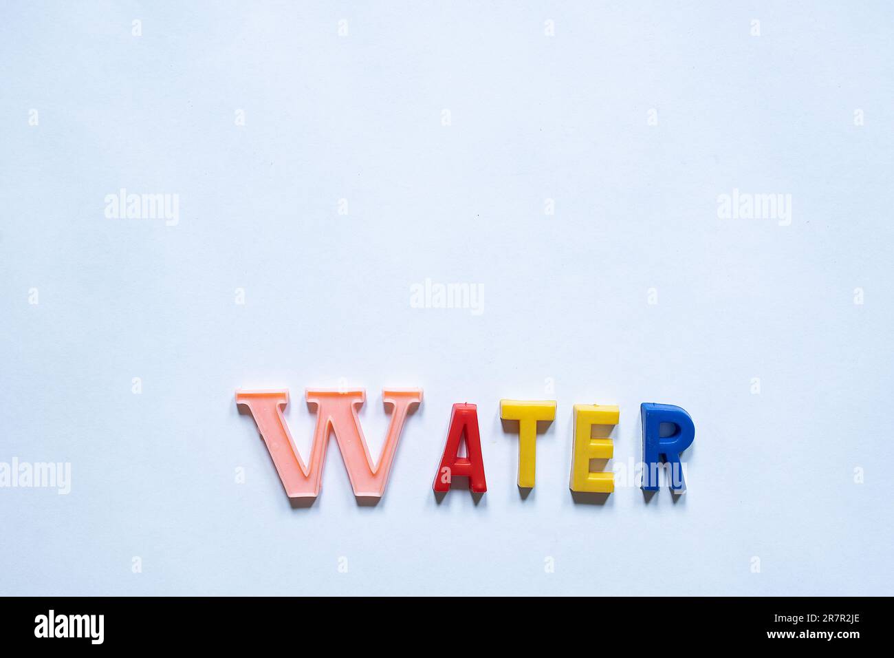 The word "WATER" is created by arranging a set of 3D colorful plastic ...