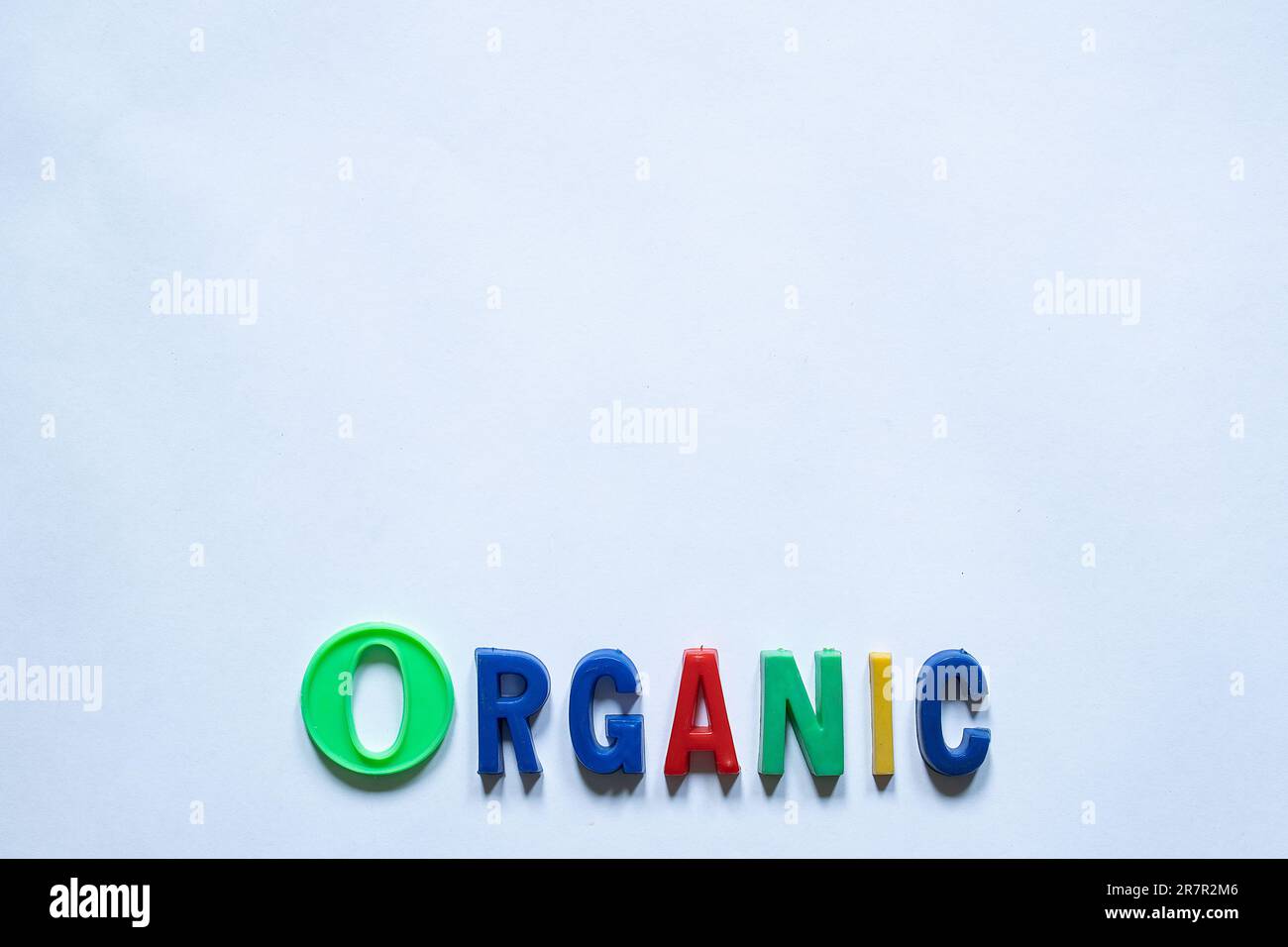 The word "ORGANIC" is created by arranging a set of 3D colorful plastic ...