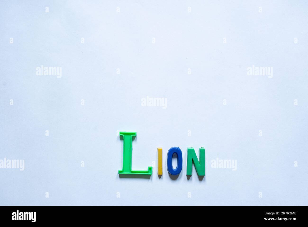 The word "LION" is created by arranging a set of 3D colorful plastic ...