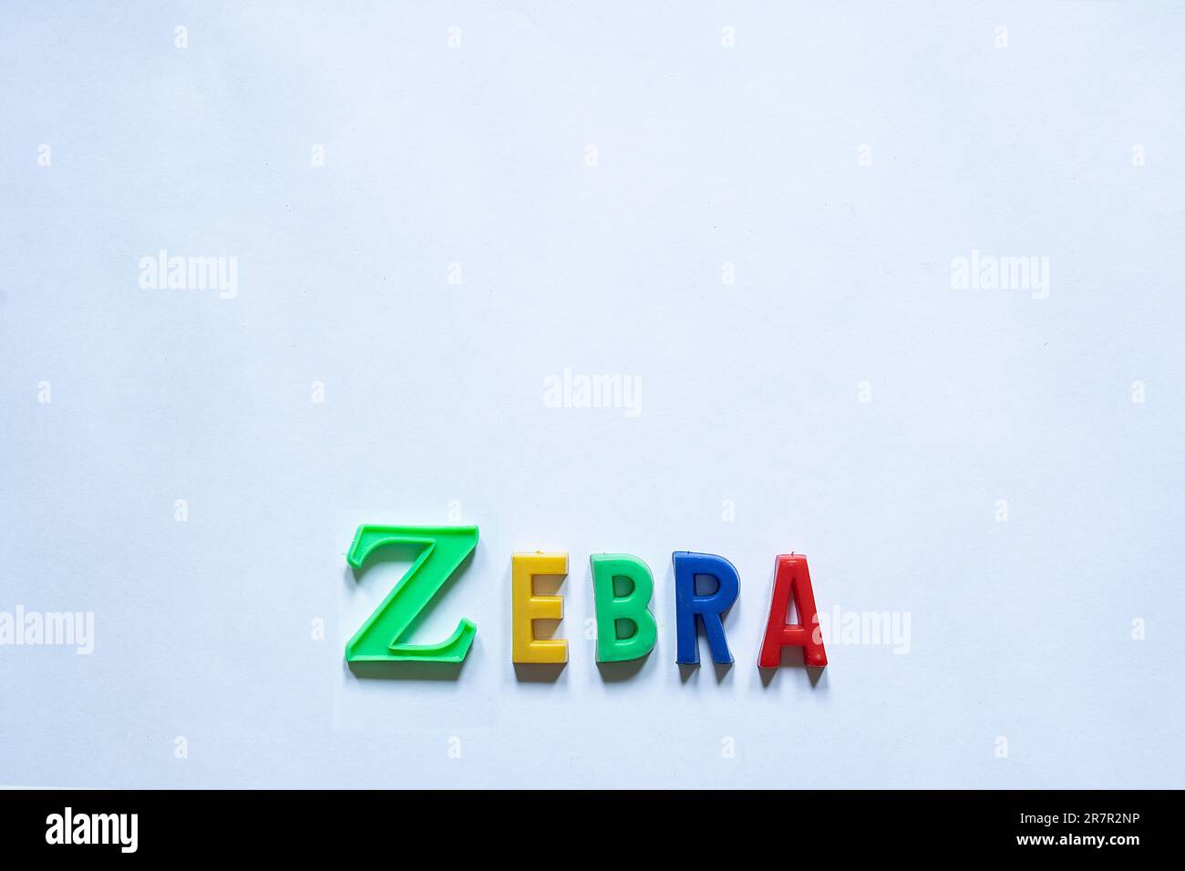 The word "ZEBRA" is created by arranging a set of 3D colorful plastic ...