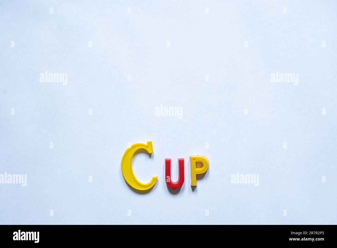 The word "CUP" is created by arranging a set of 3D colorful plastic ...