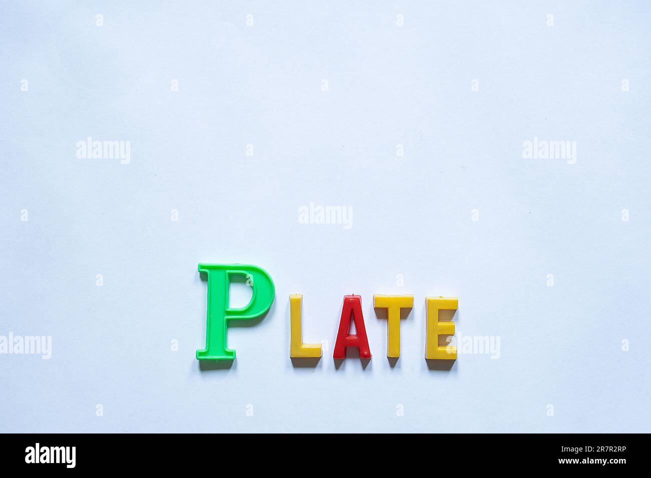 The word "PLATE" is created by arranging a set of 3D colorful plastic ...