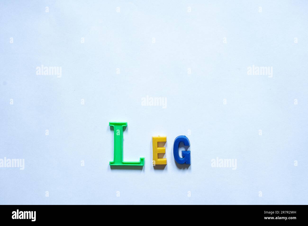 The word "LEG" is created by arranging a set of 3D colorful plastic ...