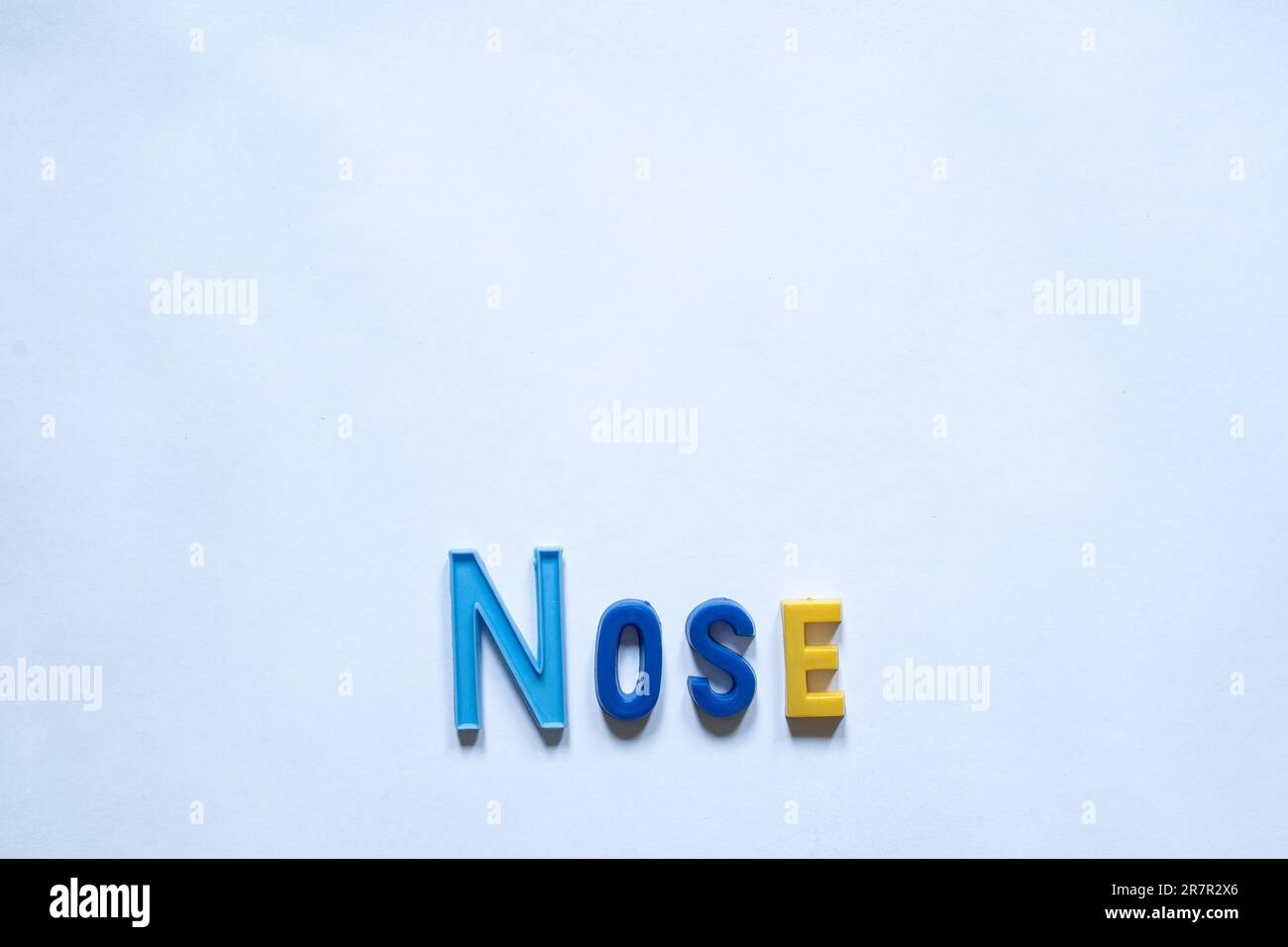 The word "NOSE" is created by arranging a set of 3D colorful plastic ...