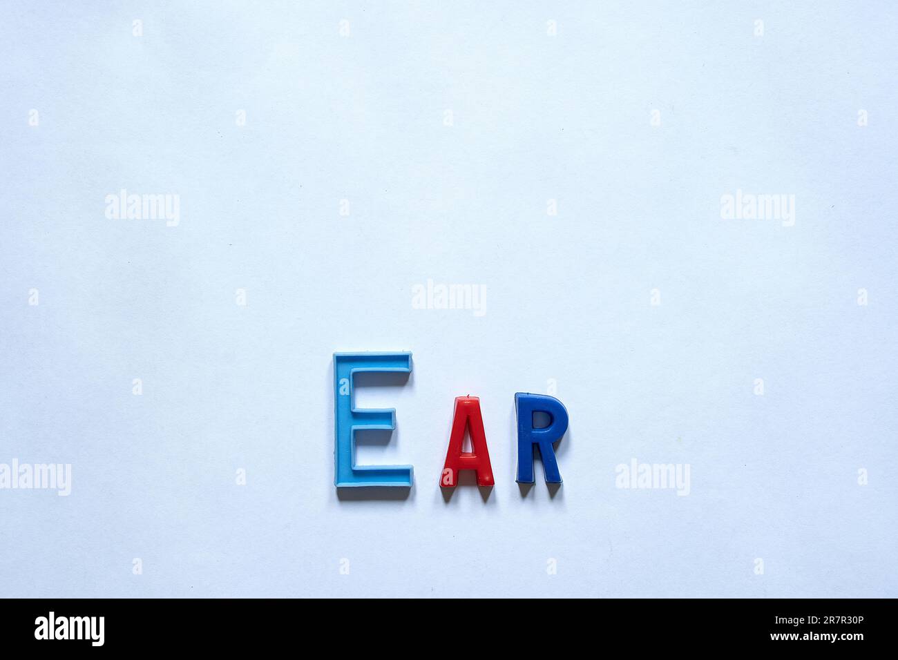 The word "EAR" is created by arranging a set of 3D colorful plastic ...