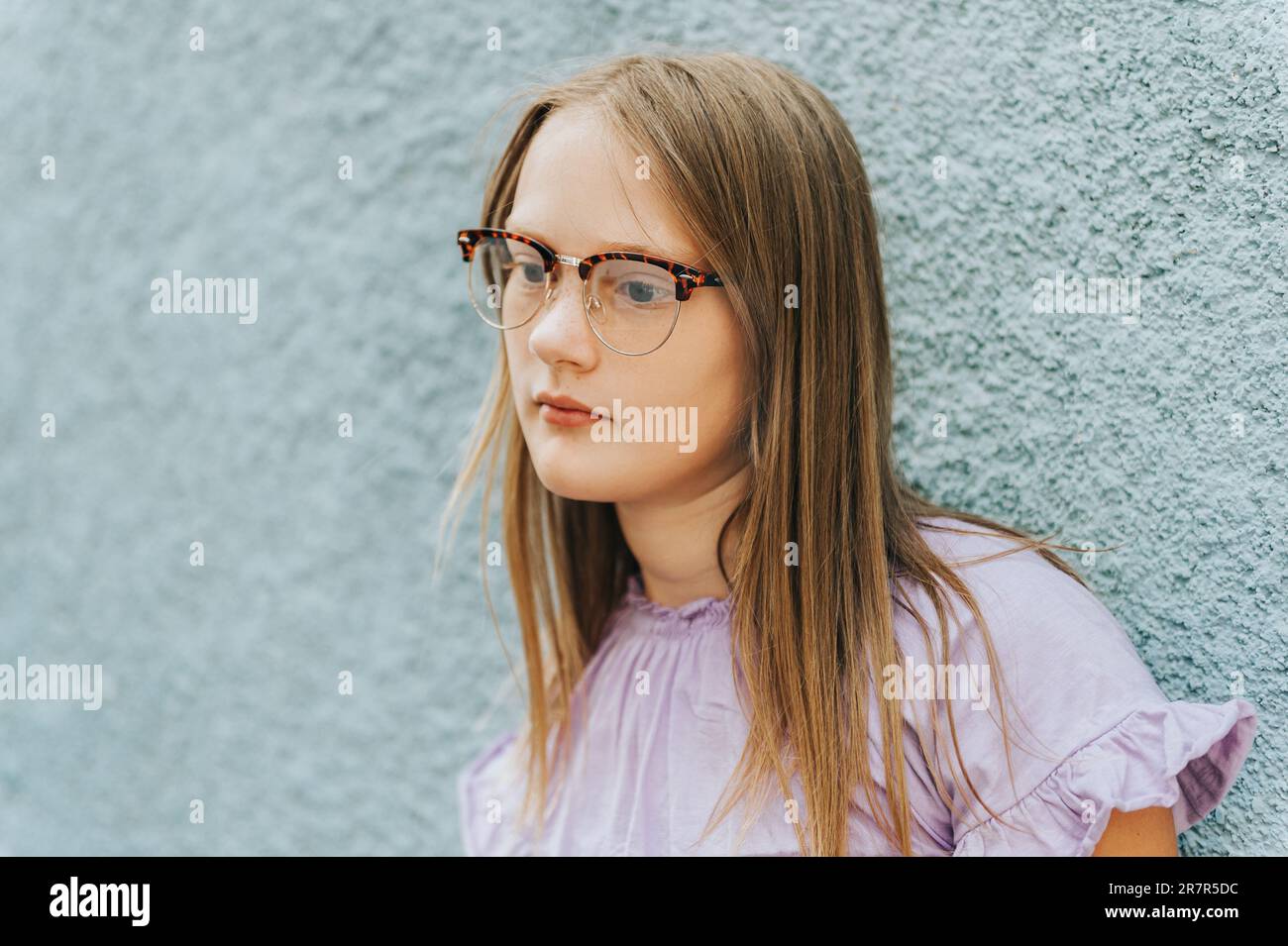 Outdoor portrait of a cute little 10-12 year old preteen girl, wearing ...