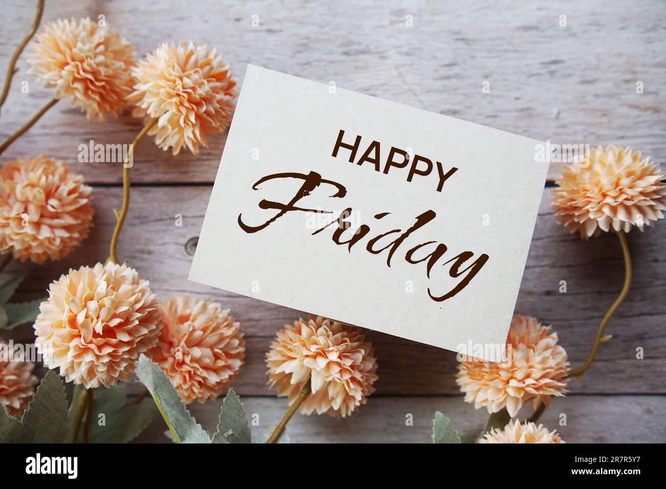 Happy Friday text message with flower decoration on wooden background ...