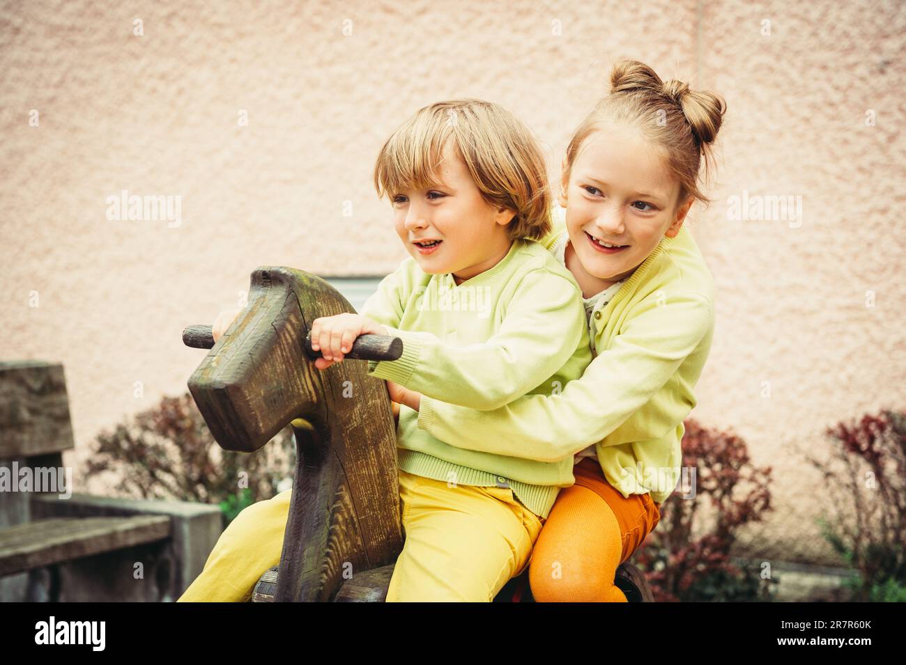 Two funny kids playing on playground, little boy and girl having fun ...