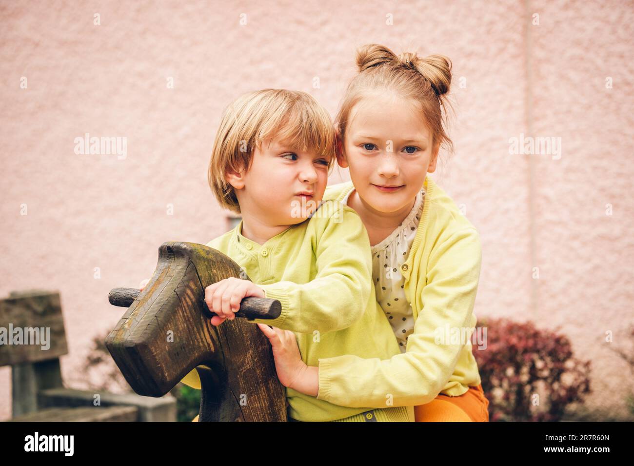 Two funny kids playing on playground, little boy with funny facial ...