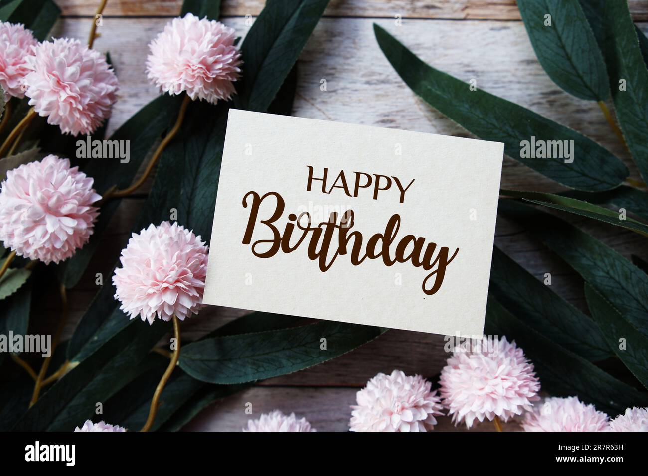 Happy Birthday text message with flower decoration on wooden background ...