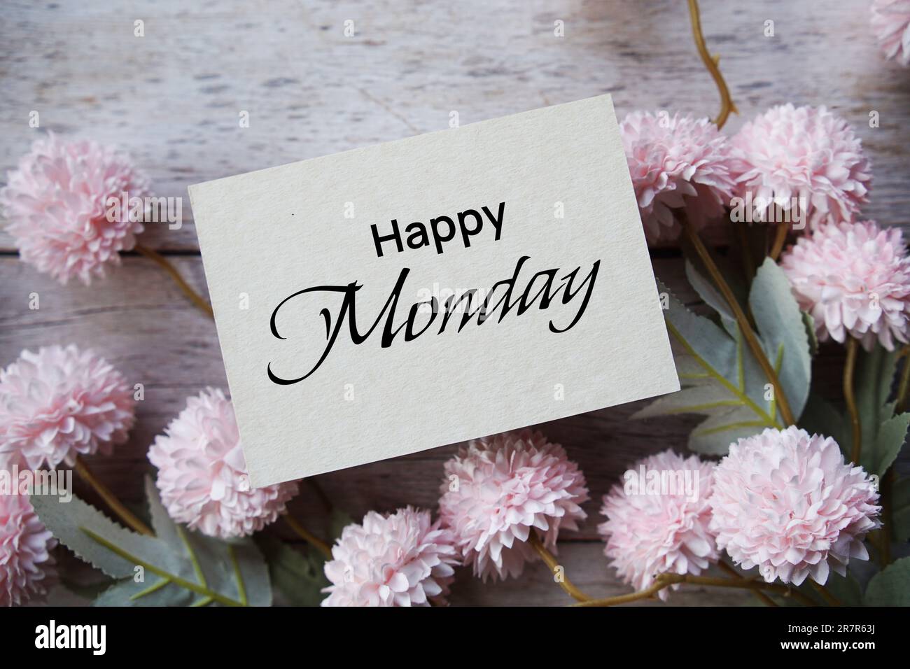 Happy Monday text message with flower decoration on wooden background ...