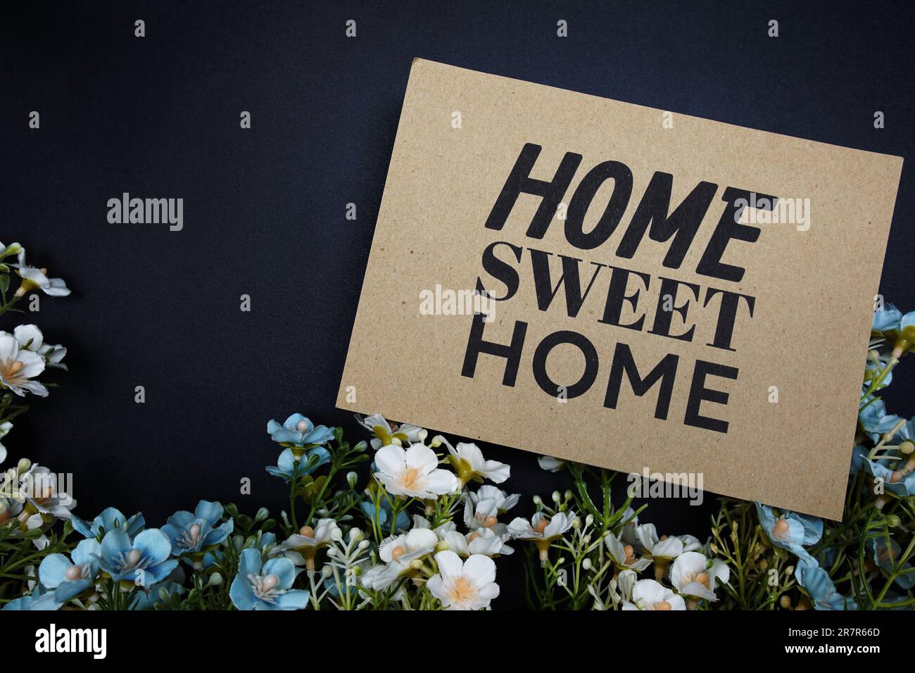 Home Sweet Home text message with flower decoration on black background ...