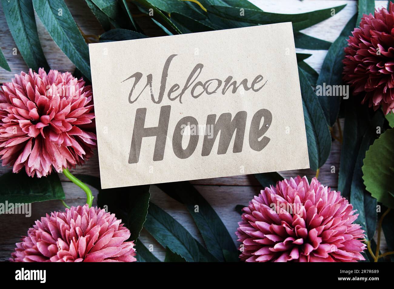 Welcome Home text message with flower decoration on wooden background ...