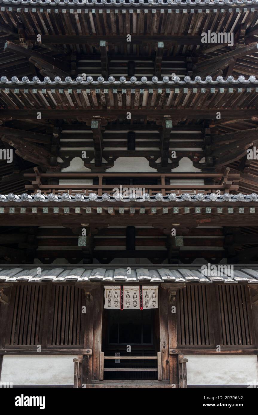 An aerial view of a tall, modern Asian building with a set of wide ...