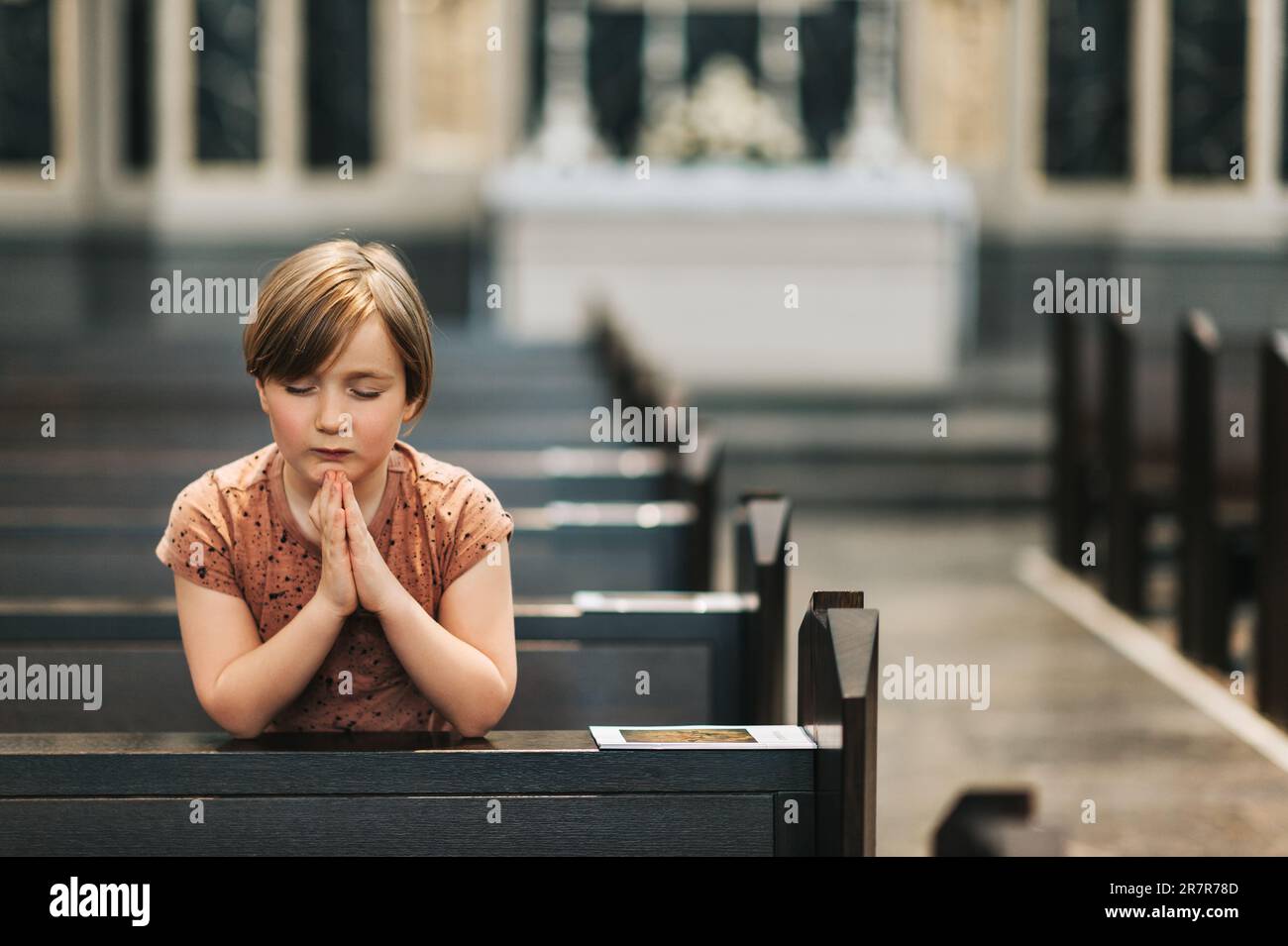 Little boy praying in church Stock Photo - Alamy