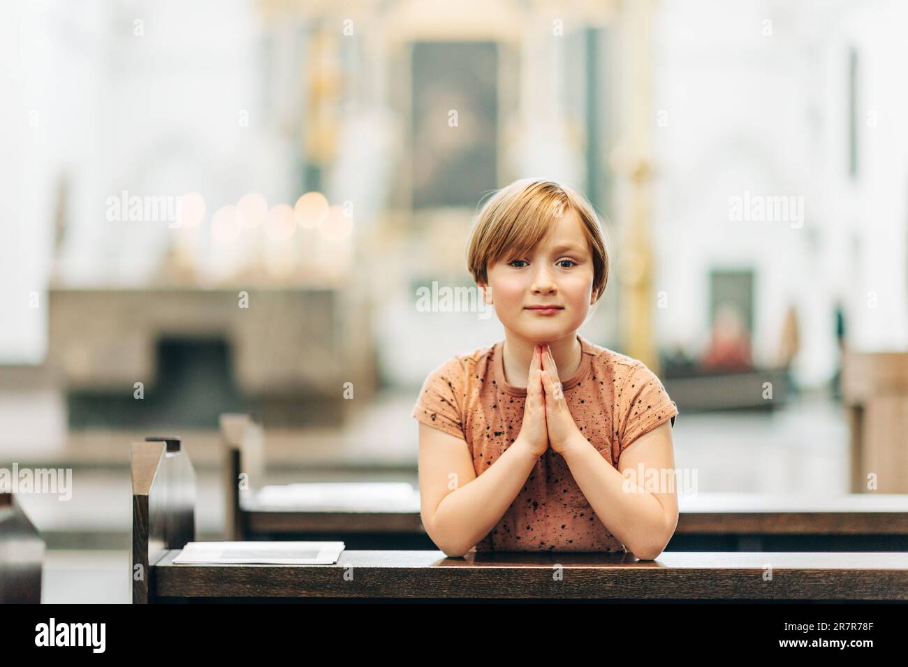 Little boy praying in church Stock Photo - Alamy