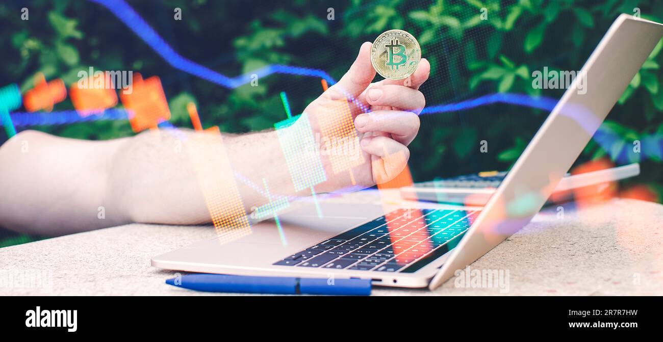 Laptop with chart and bitcoin in hands. Cryptocurrency gold coin, stock ...