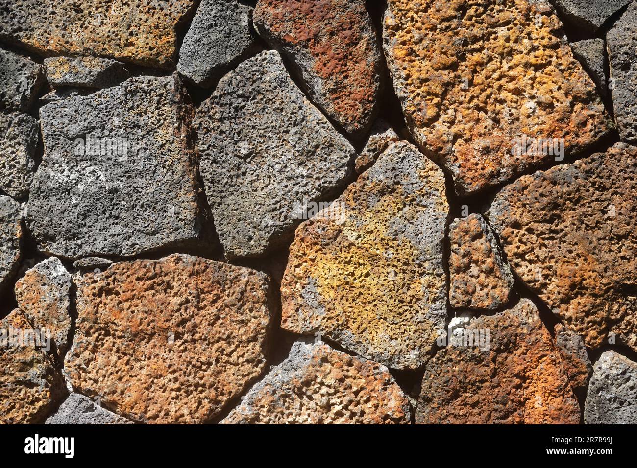 Wall built from lava stones Stock Photo - Alamy