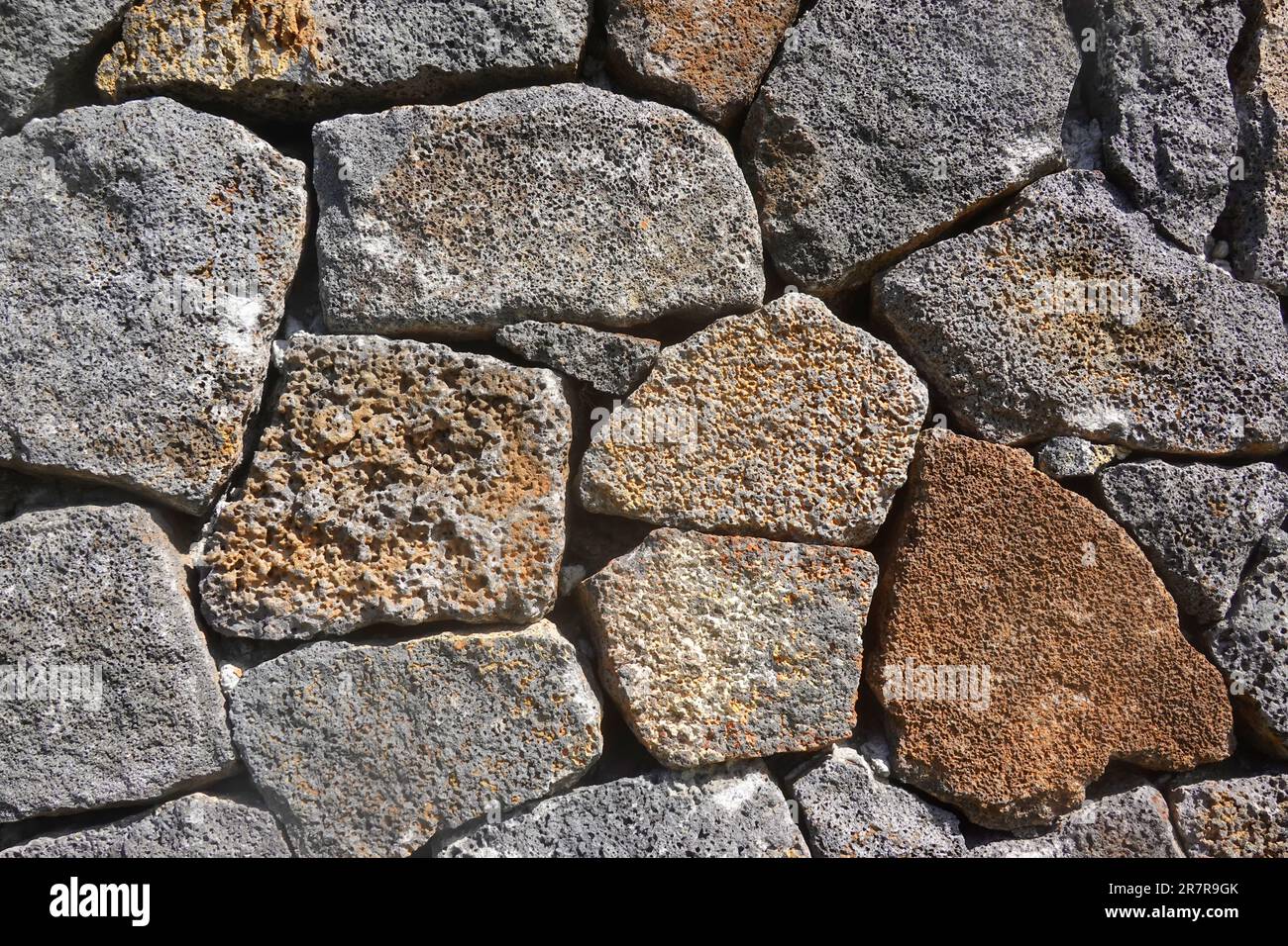 Wall built from lava stones Stock Photo - Alamy