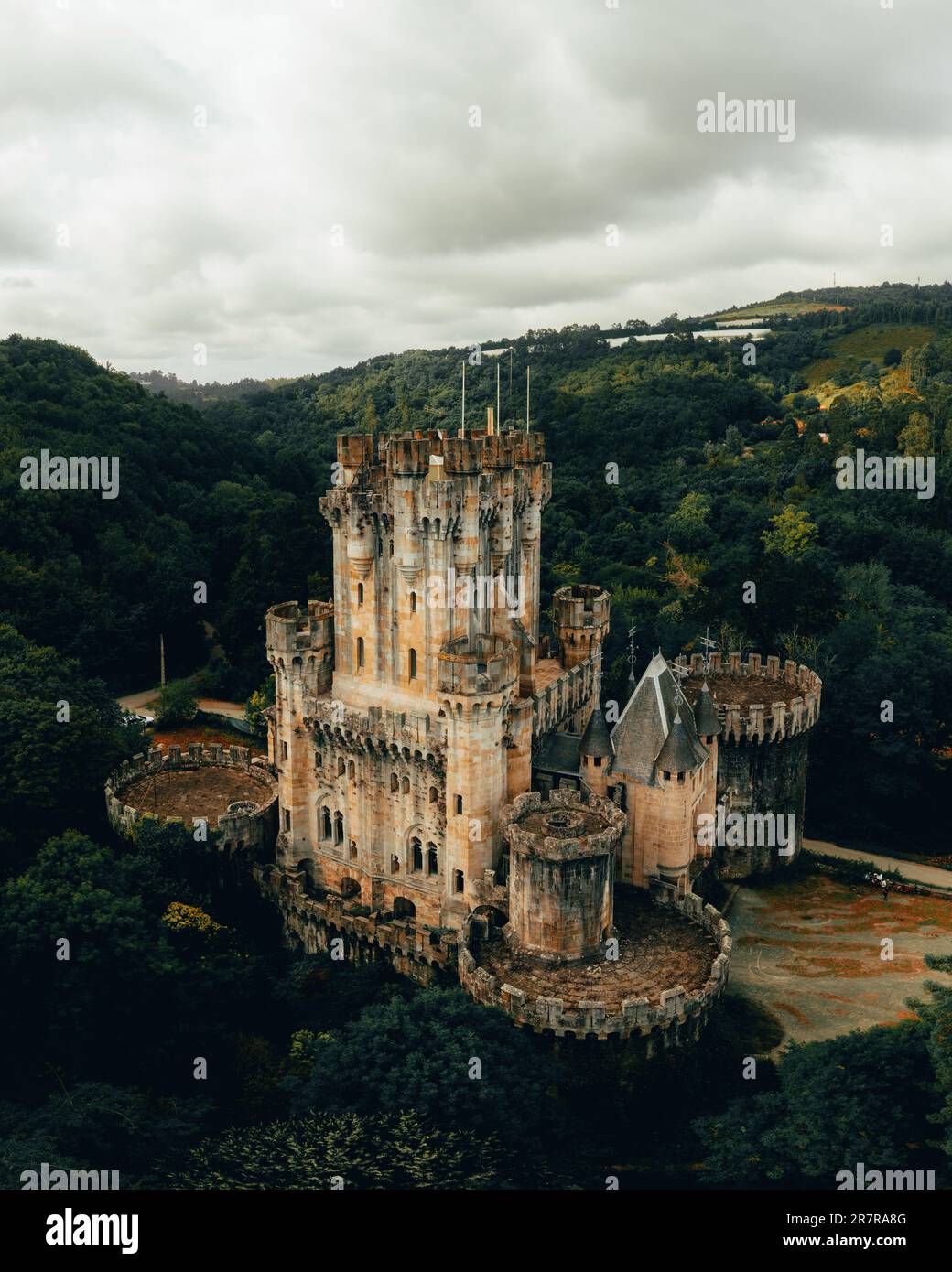 An enchanting aerial view of Butron Castle, nestled amidst lush ...