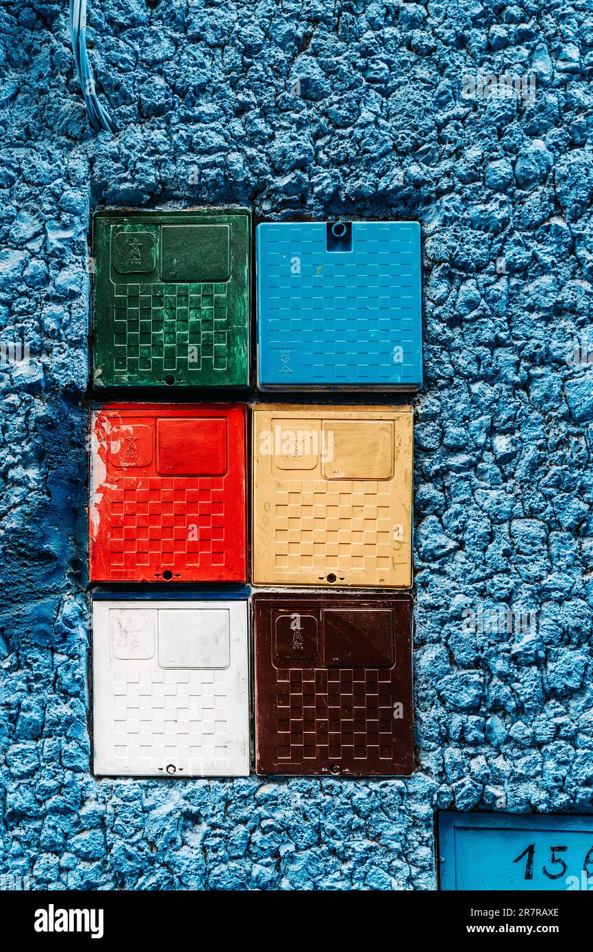 Multicolor boxes on blue wall: A lively fusion of colors, these vibrant ...