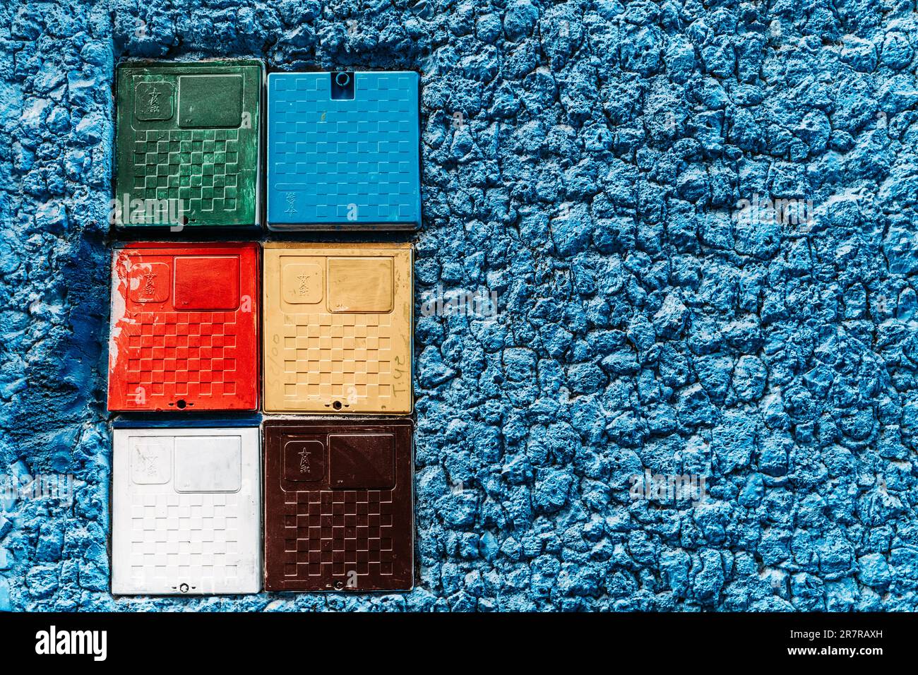 Multicolor boxes on blue wall: A lively fusion of colors, these vibrant ...