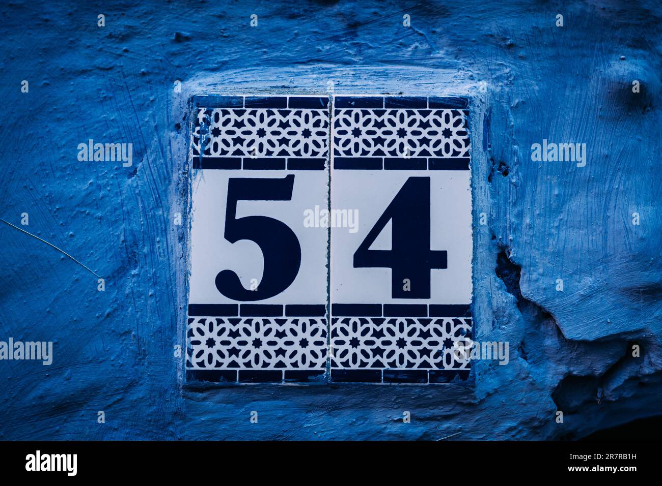 Vibrant blue house post: Numbers adorn this eye-catching house post ...