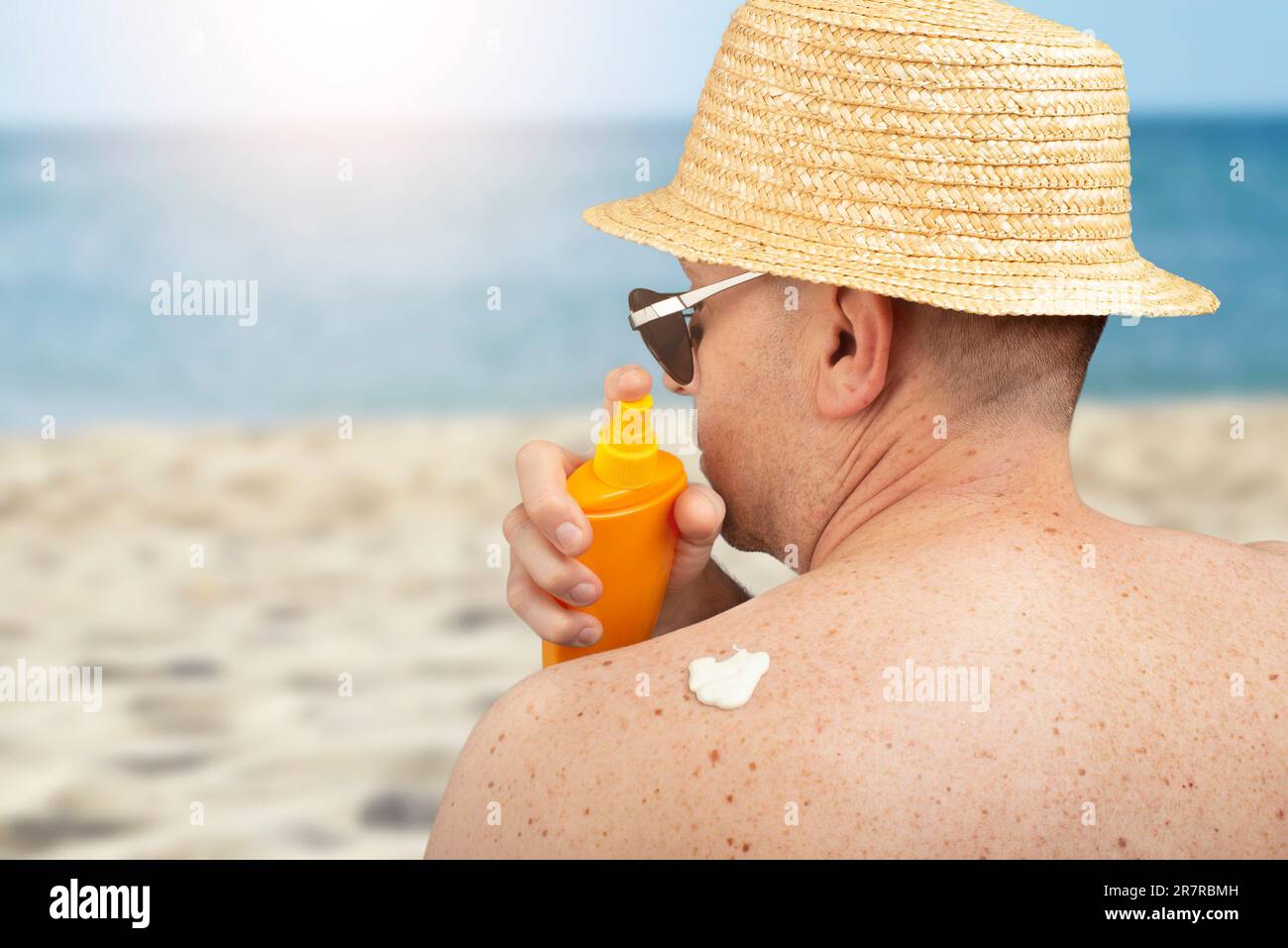 Middle aged caucasian male model applying sunscreen Stock Photo - Alamy