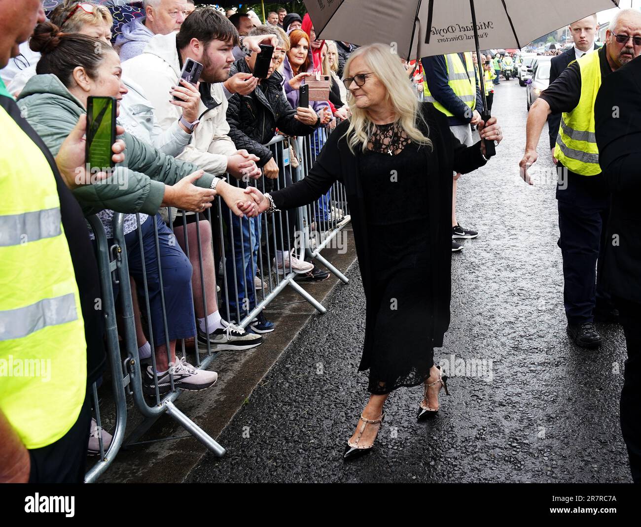 Aslan frontman Christy Dignam's wife Kathryn(centre) is consoled by ...