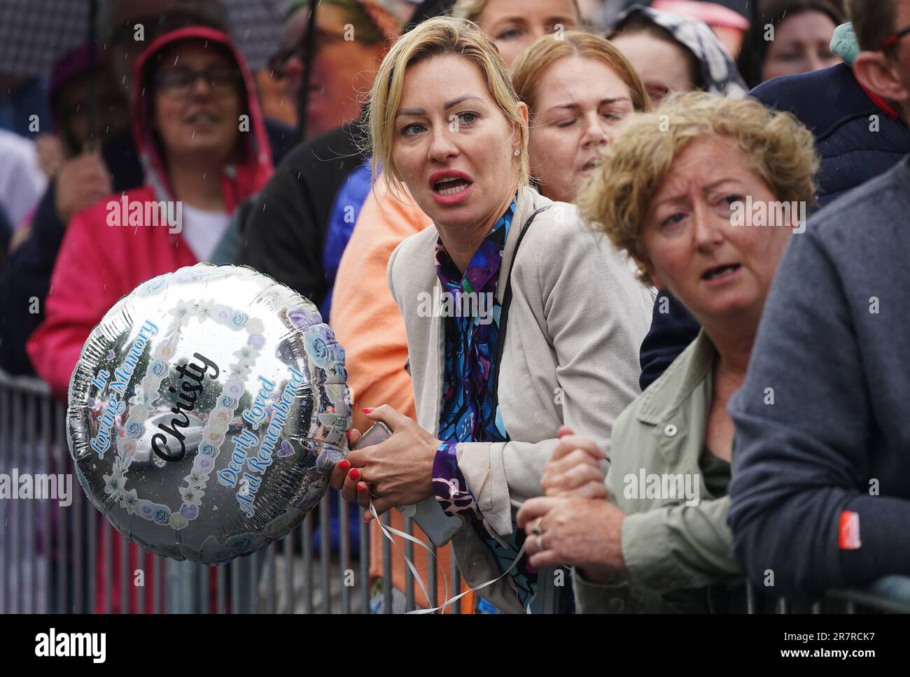 People line the streets of Finglas, Dublin, for a farewell gathering ...