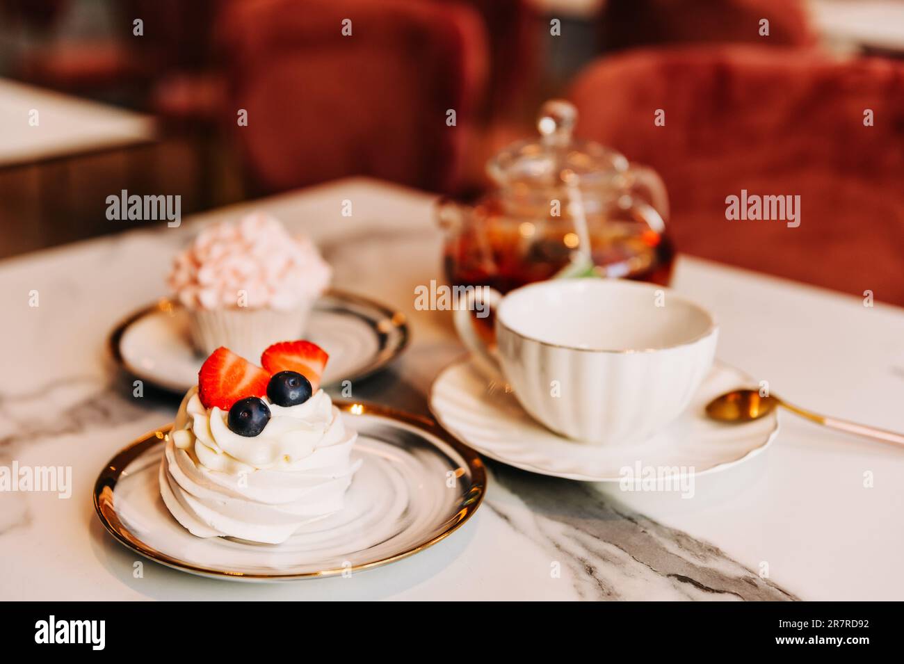 Tea with dessert, served table in cozy tea room Stock Photo - Alamy