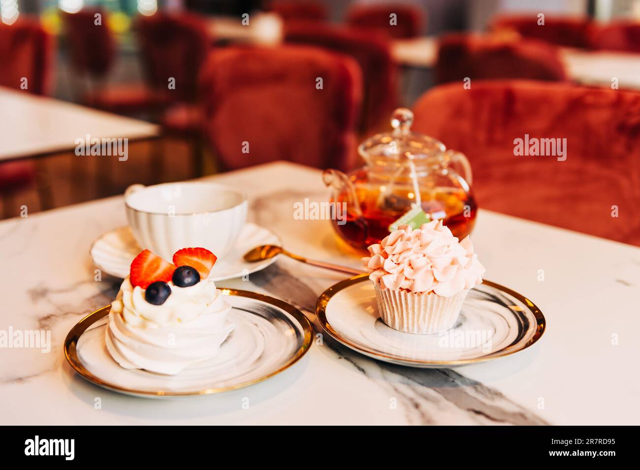 Tea with dessert, served table in cozy tea room Stock Photo - Alamy