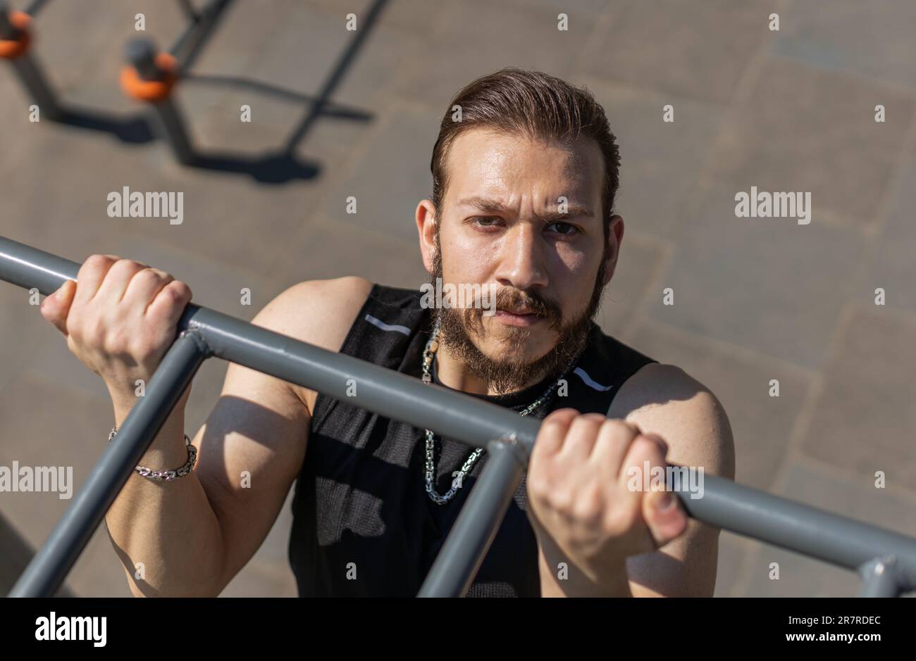 Athletic lebanese man in sportswear doing pull ups exercises on ...