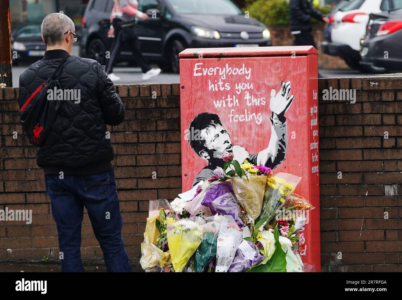 A man takes a photo of a mural of Aslan frontman Christy Dignam in ...