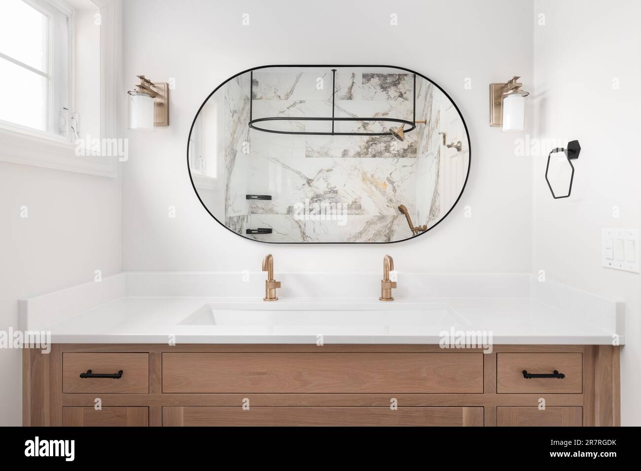 A beautiful bathroom with a white oak cabinet, marble countertop, gold ...