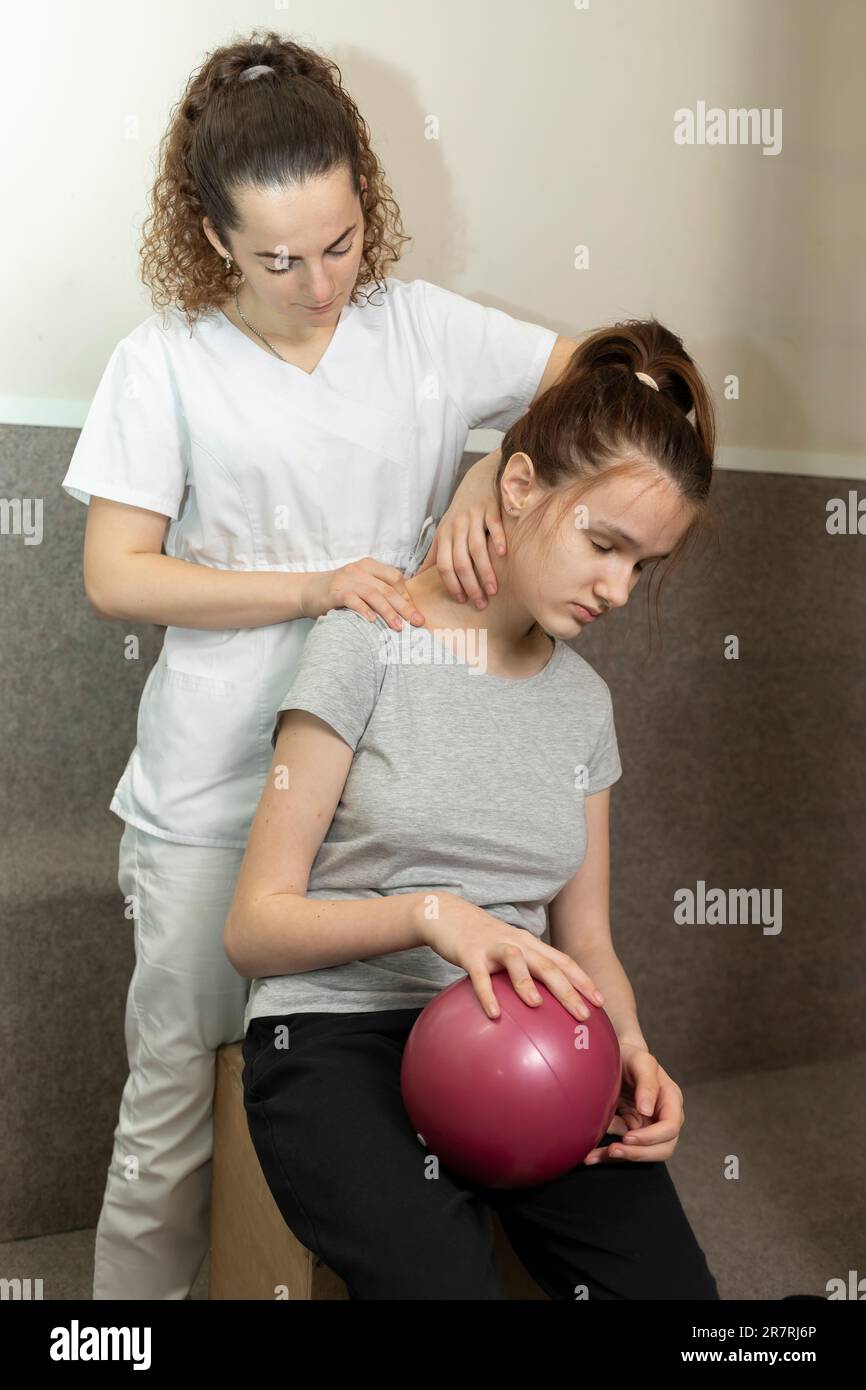 Physical Therapist Does Neck Massage To Child With Disability. Muscle ...