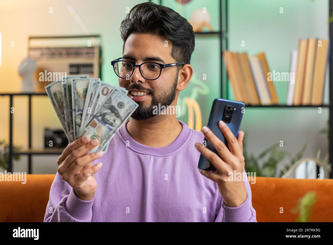 Planning family budget. Smiling indian man counting money cash, use ...