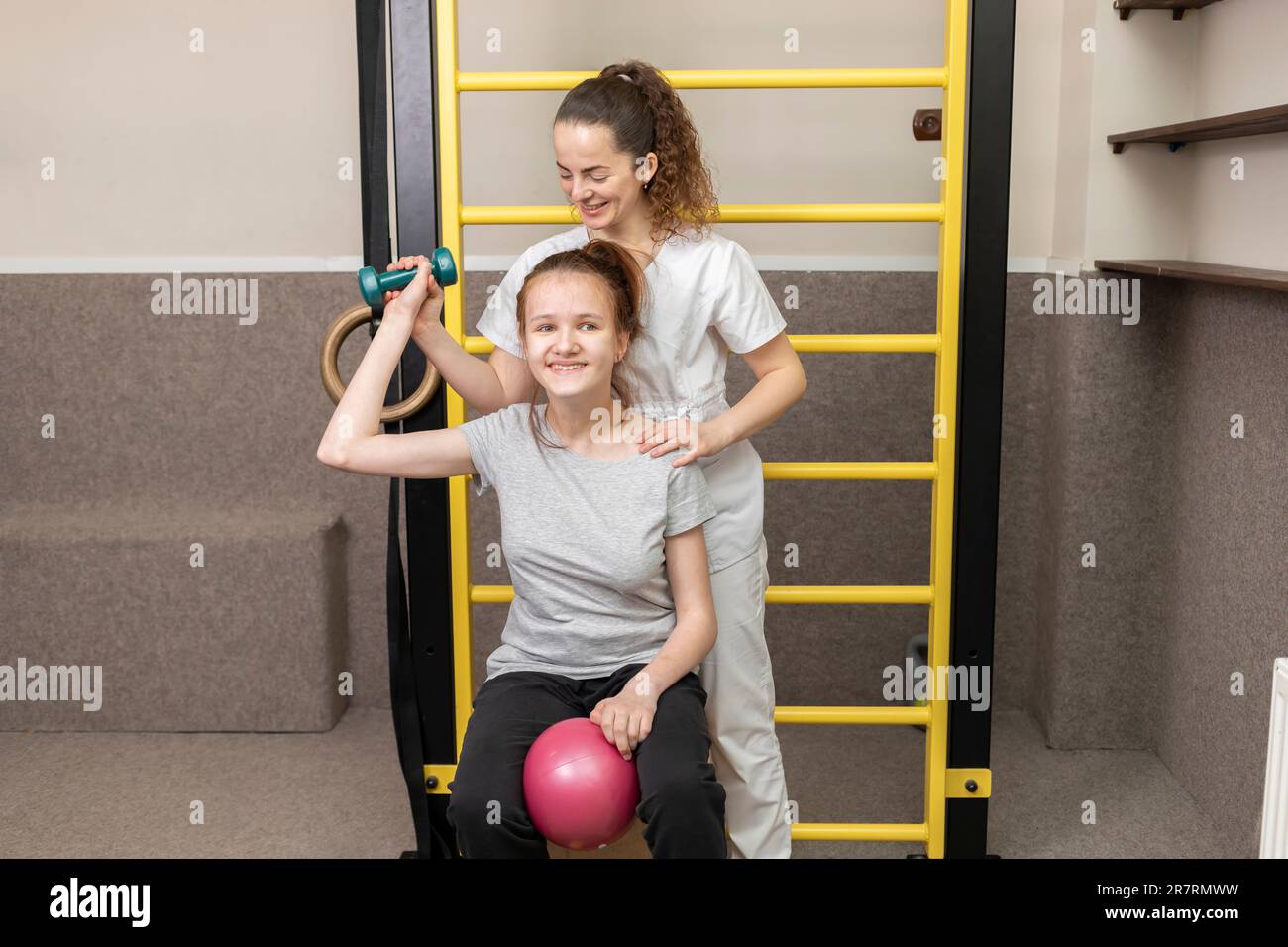 Physician Helps Happy Disabled Child Raise Dumbbell, Do Physical ...