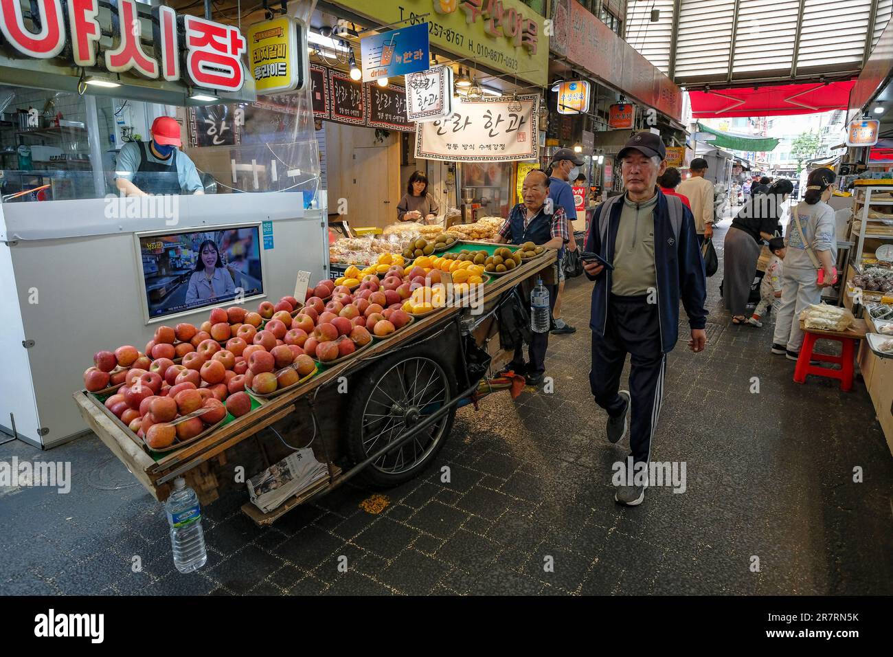 Busan, South Korea - May 26, 2023: A fruit seller in the Gukje Market ...