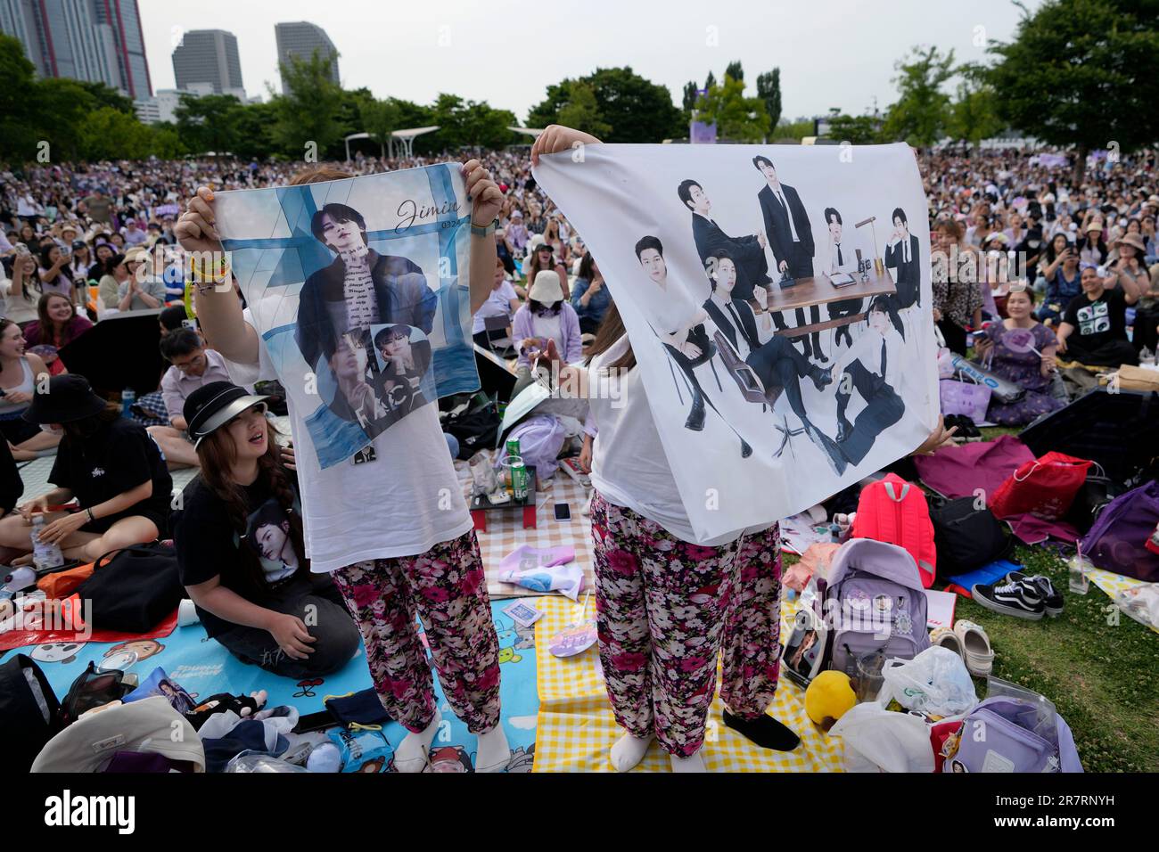 Fans of BTS hold banners showing K-pop band BTS members during an event ...