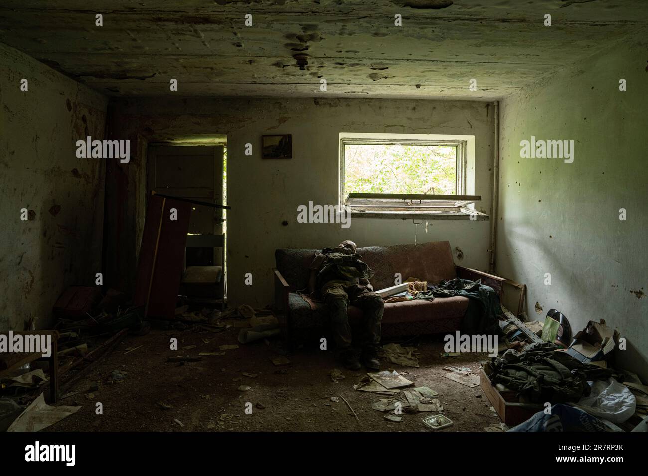 The body of a killed Russian soldier is seen on a sofa in the recently ...
