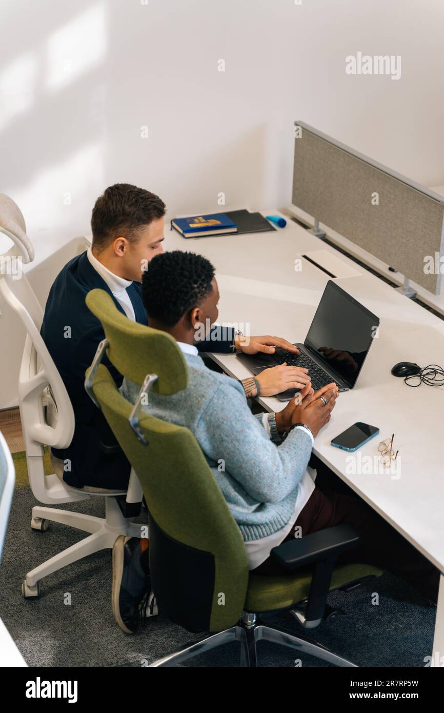 A junior worker is struggling with his daily task. He is getting help ...